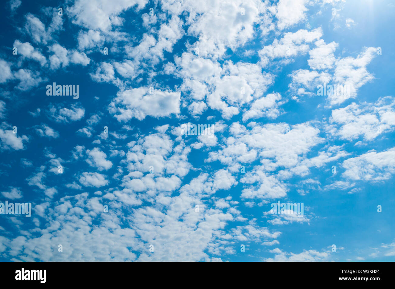 Blue dramatic sky background - white dramatic colorful clouds lit by ...