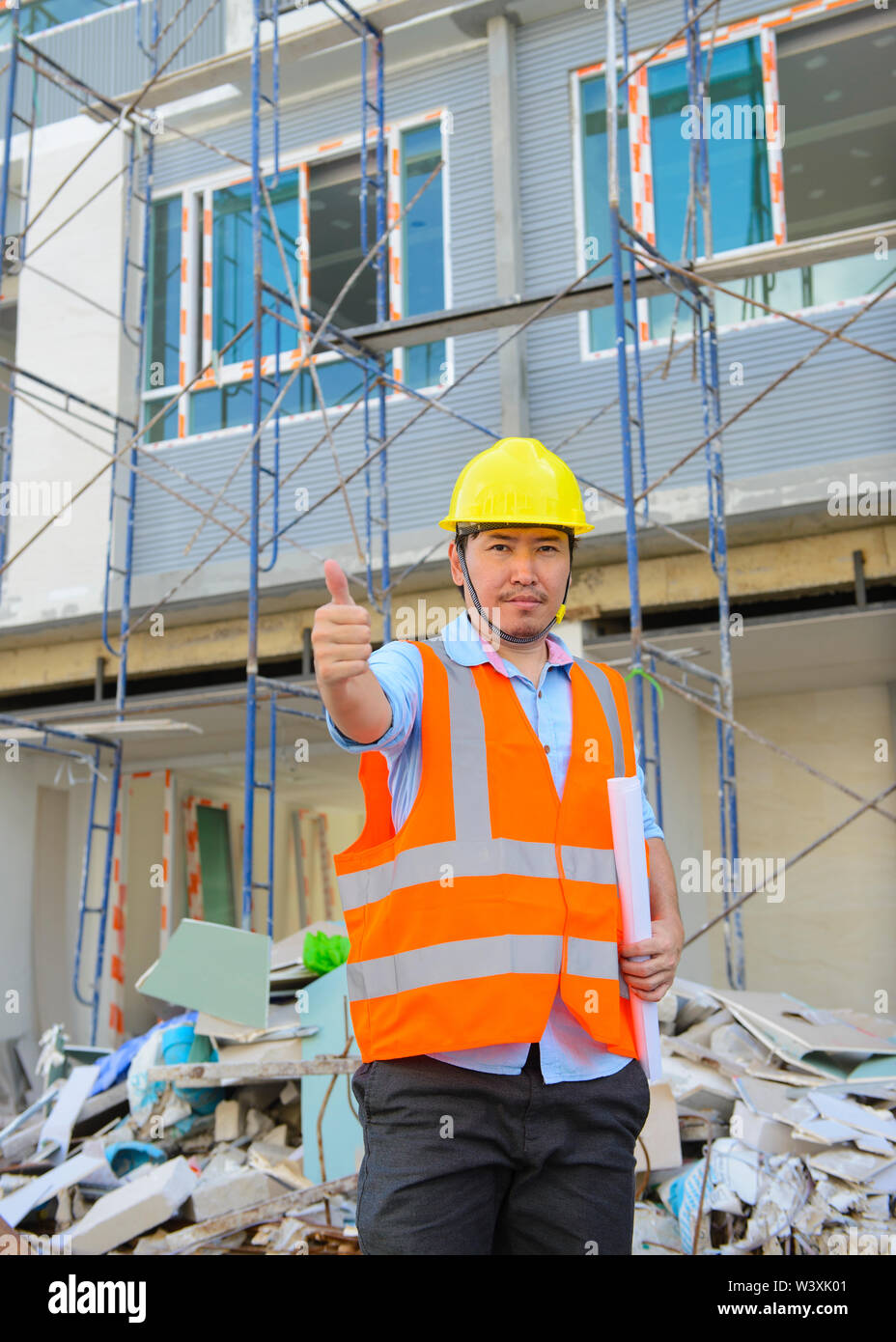 Asian foreman thumb up at construction site Stock Photo - Alamy