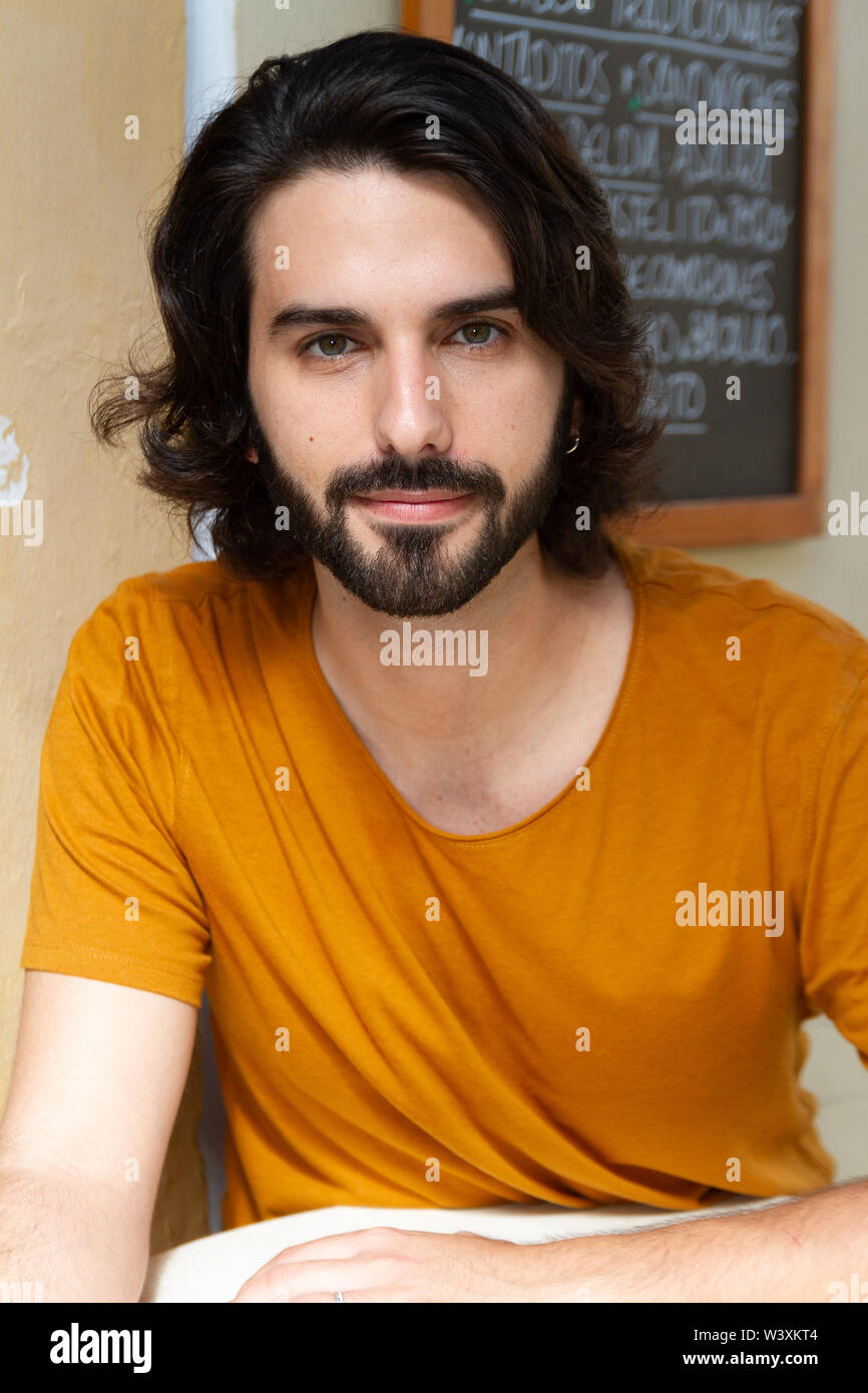 portraits of a young man on a terrace, looking at camera in colour like ...