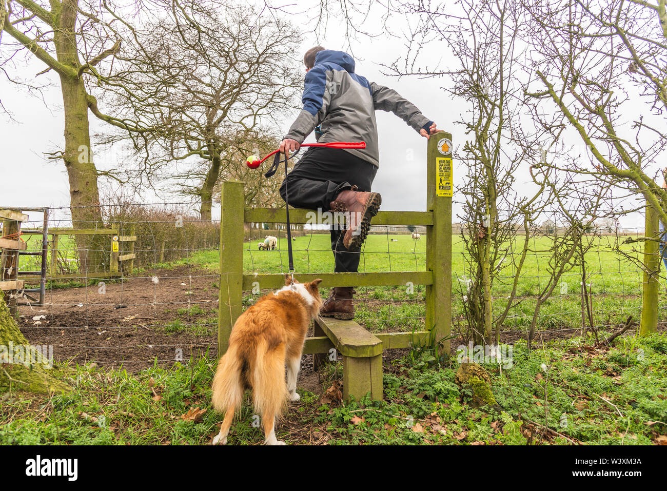Man climbing over fence hi-res stock photography and images - Alamy