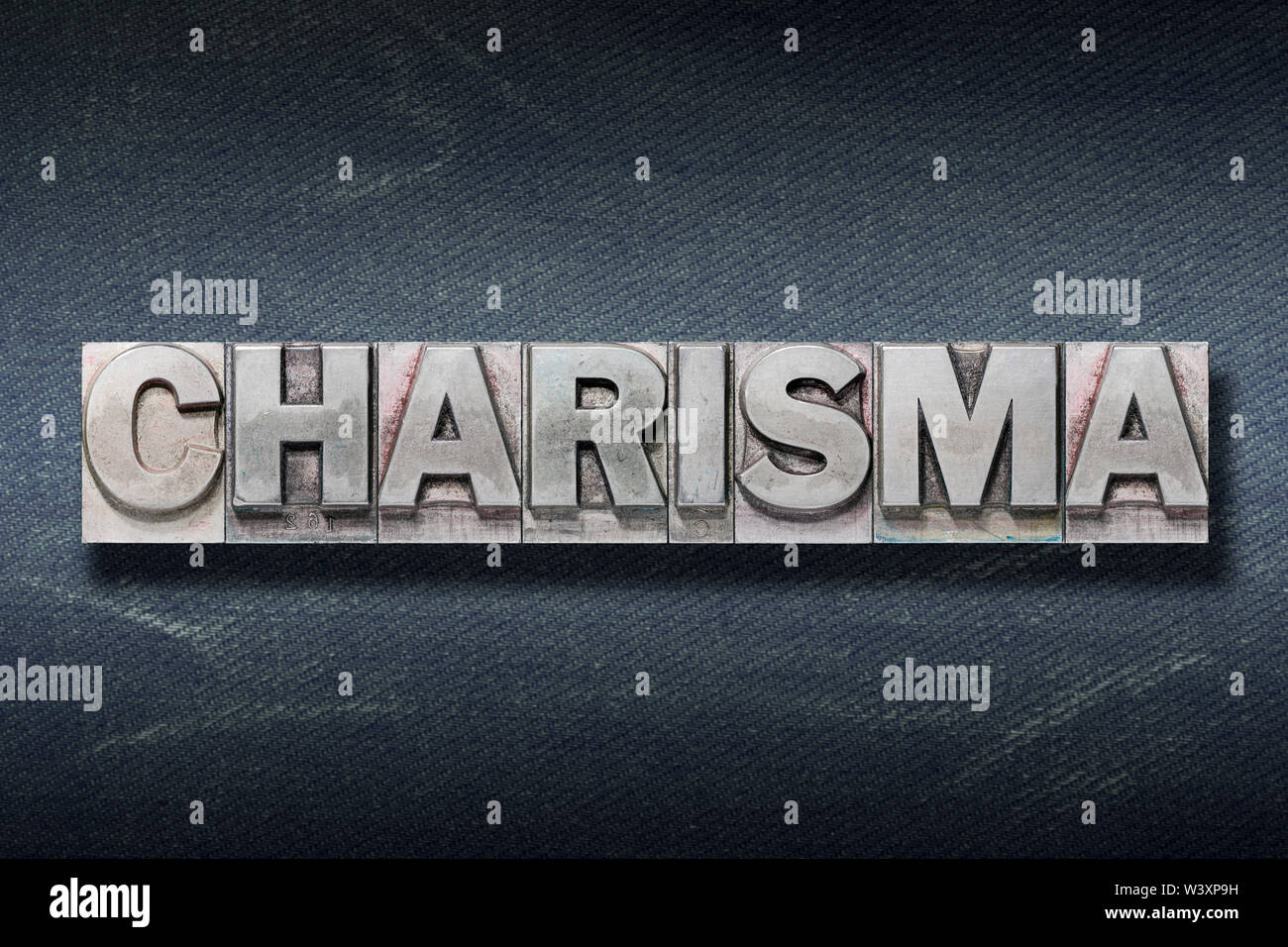 charisma word made from metallic letterpress on dark jeans background Stock Photo - Alamy
