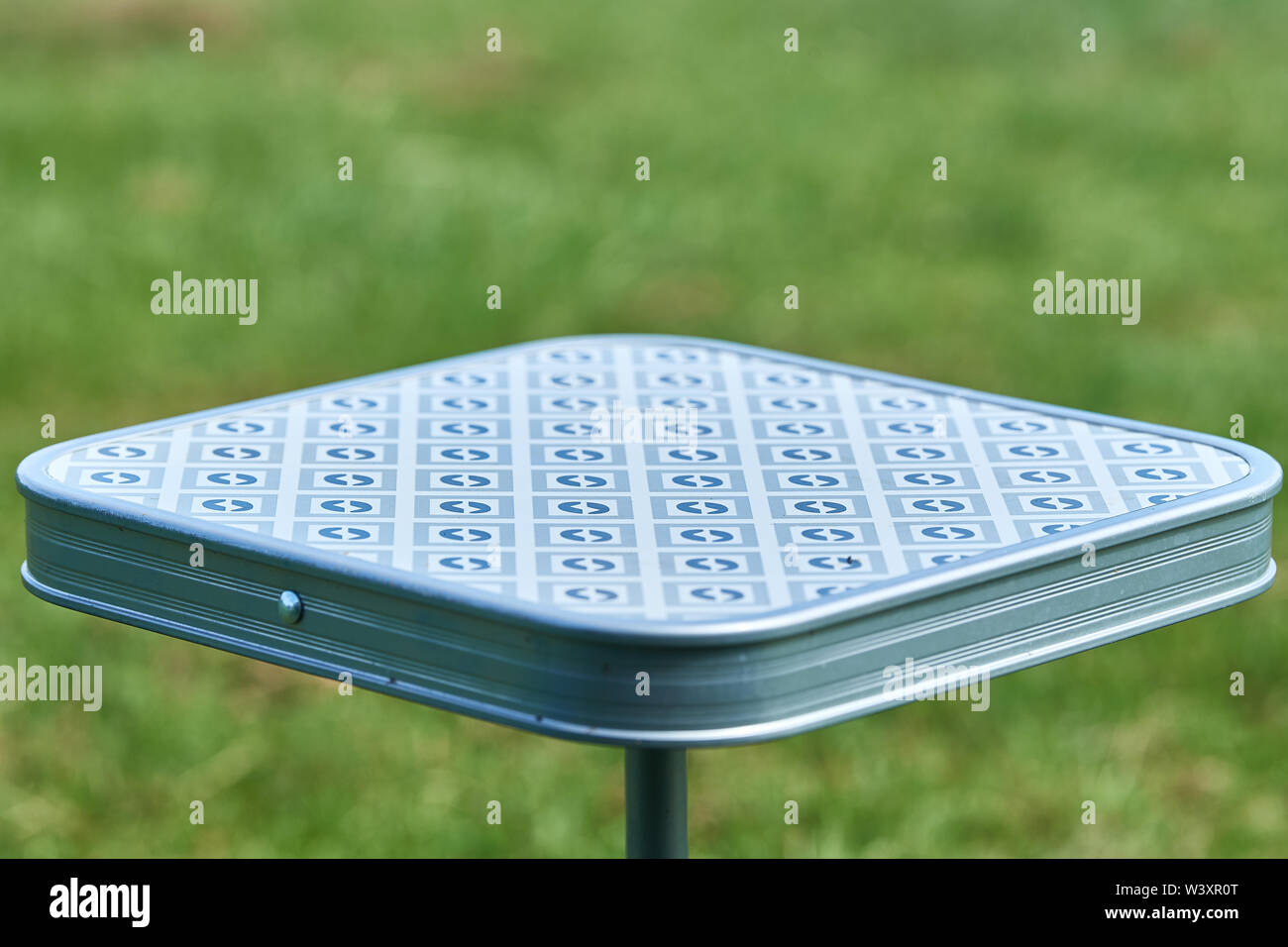 Empty small camping table staked into the ground Stock Photo - Alamy