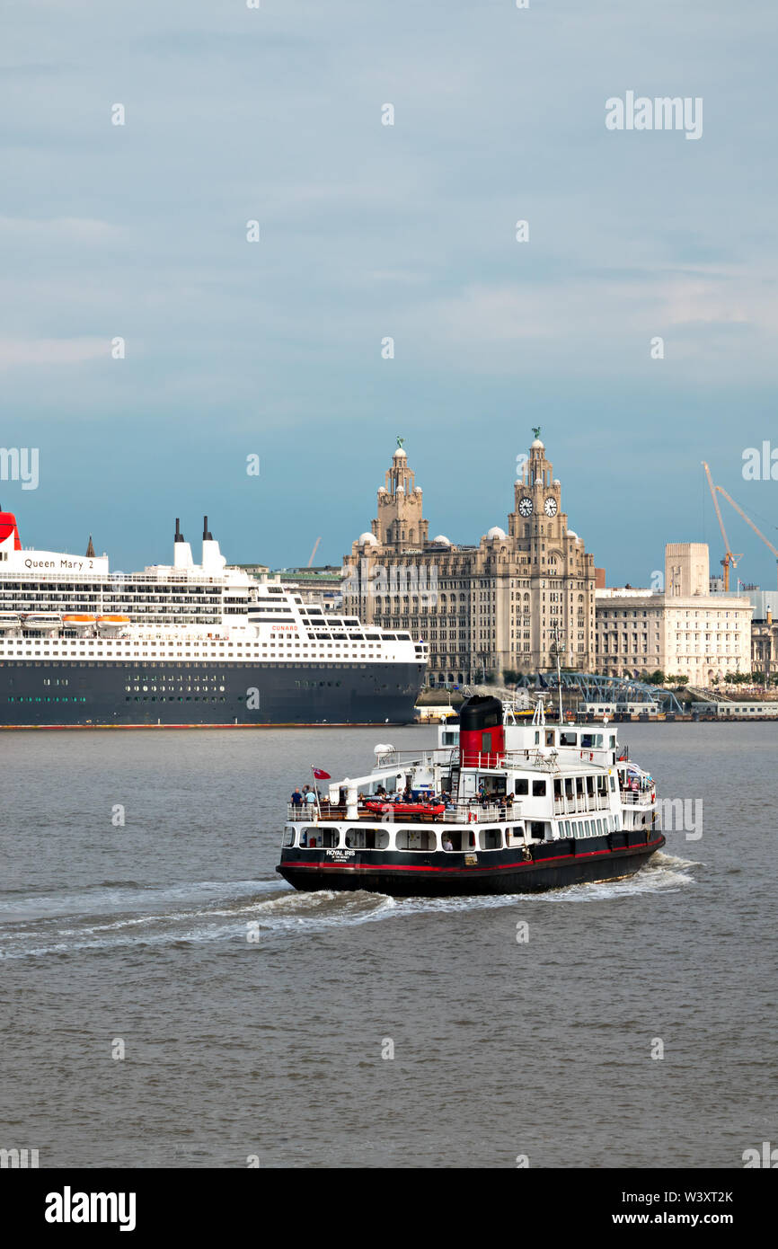 The Mersey Ferry Royal Iris passing in front of the Queen Mary 2 docked ...