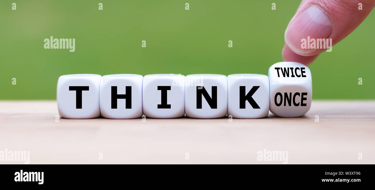 Hand turns a dice and changes the expression "think once" to "think ...