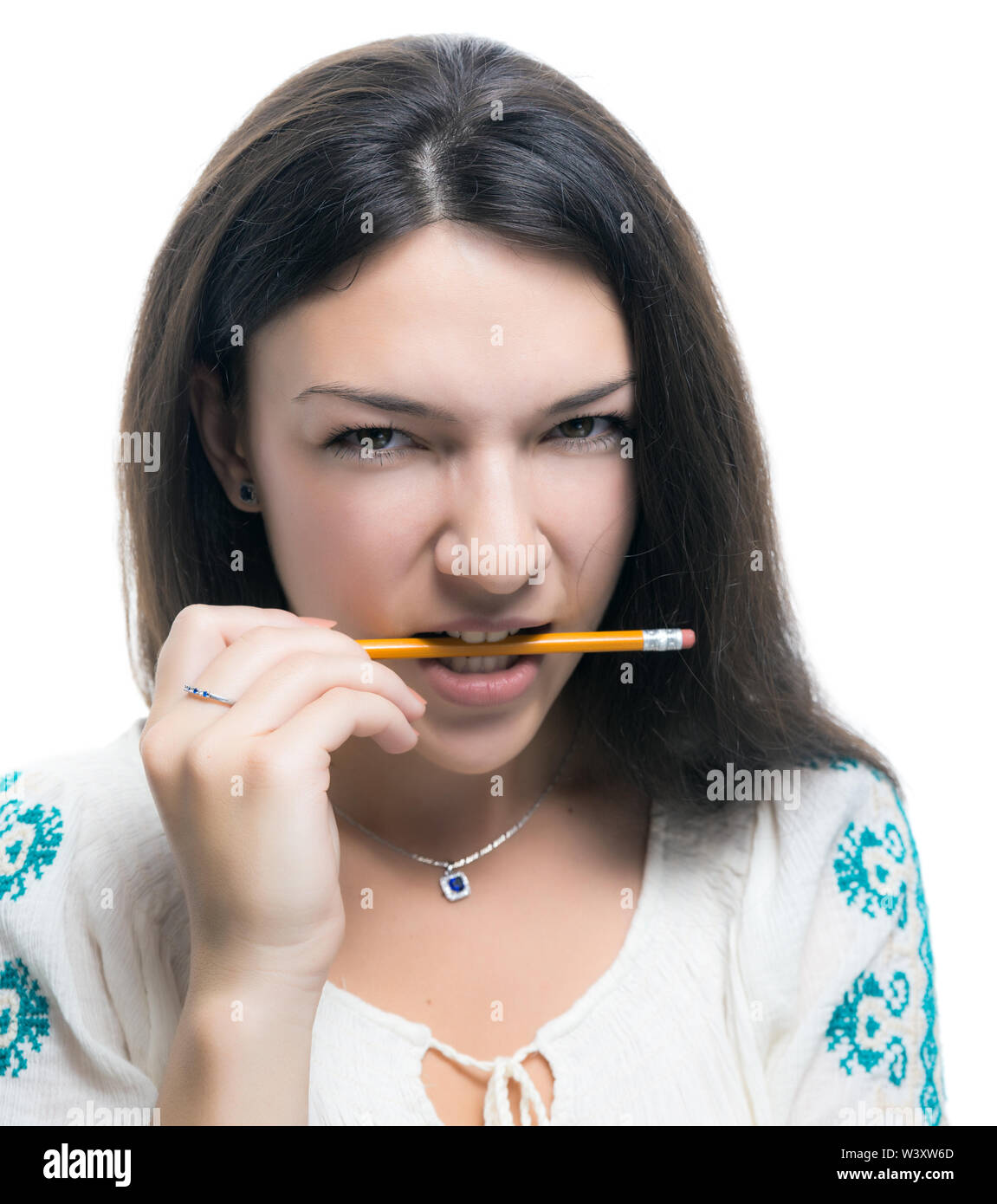 Young woman holding a pencil in her teeth on white background Stock ...