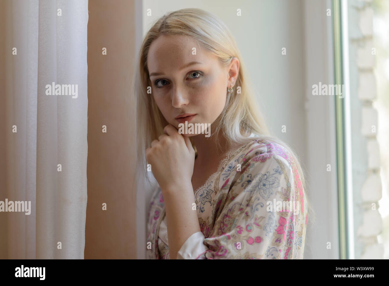 Portrait of young woman in bathrobe without retouching. Natural light ...