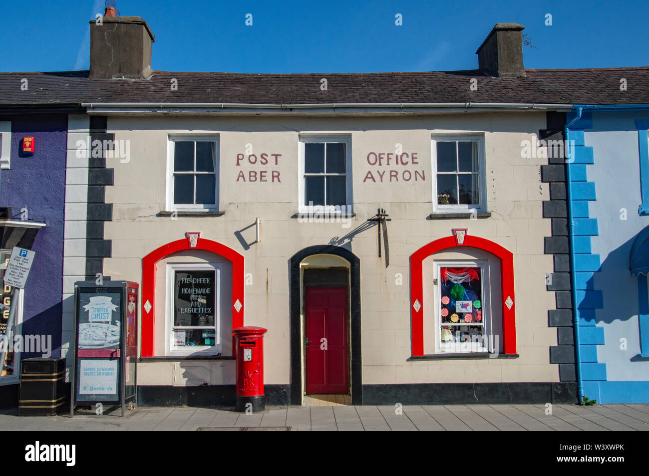 Aberaeron Post Office building, Ceredigion, Wales. Red post box and ...