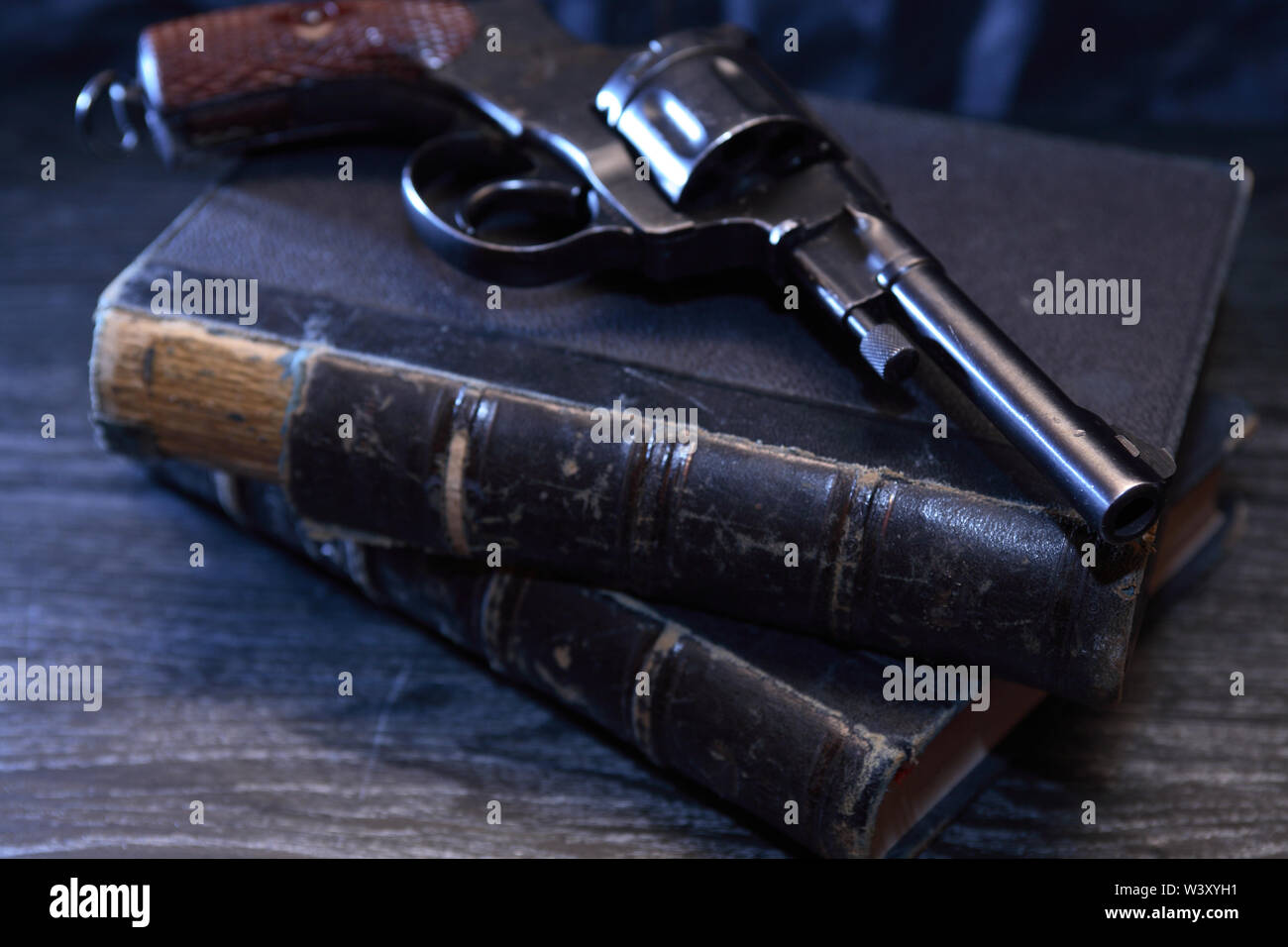 Vintage still life. Old handgun on book against dark background Stock ...
