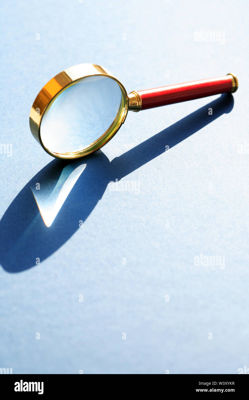 Nice retro magnifying glass under sunlight on gray background Stock ...