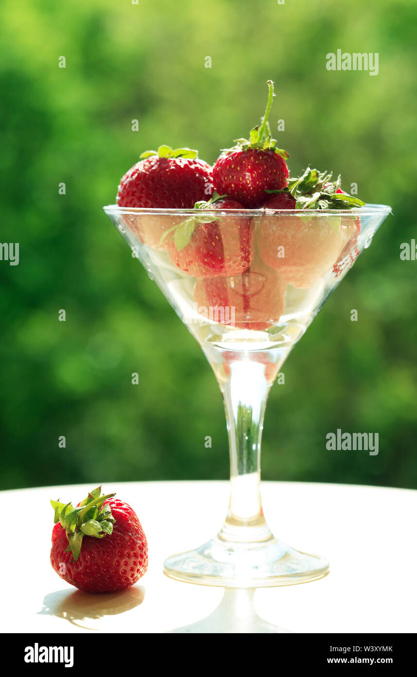 Few strawberry fruits in nice glass bowl Stock Photo - Alamy