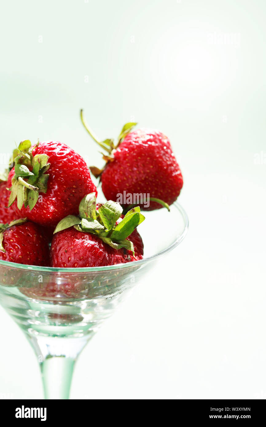 Few strawberry fruits in nice glass bowl Stock Photo - Alamy