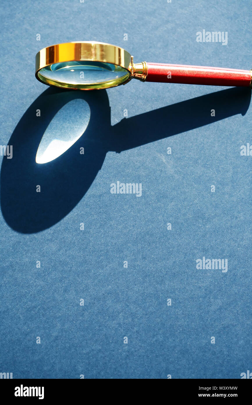 Nice retro magnifying glass under sunlight on gray background Stock ...