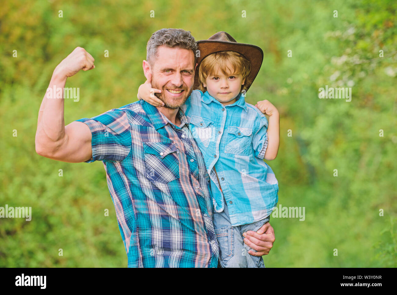 Rustic family. Growing cute cowboy. Small helper in garden. Little boy ...