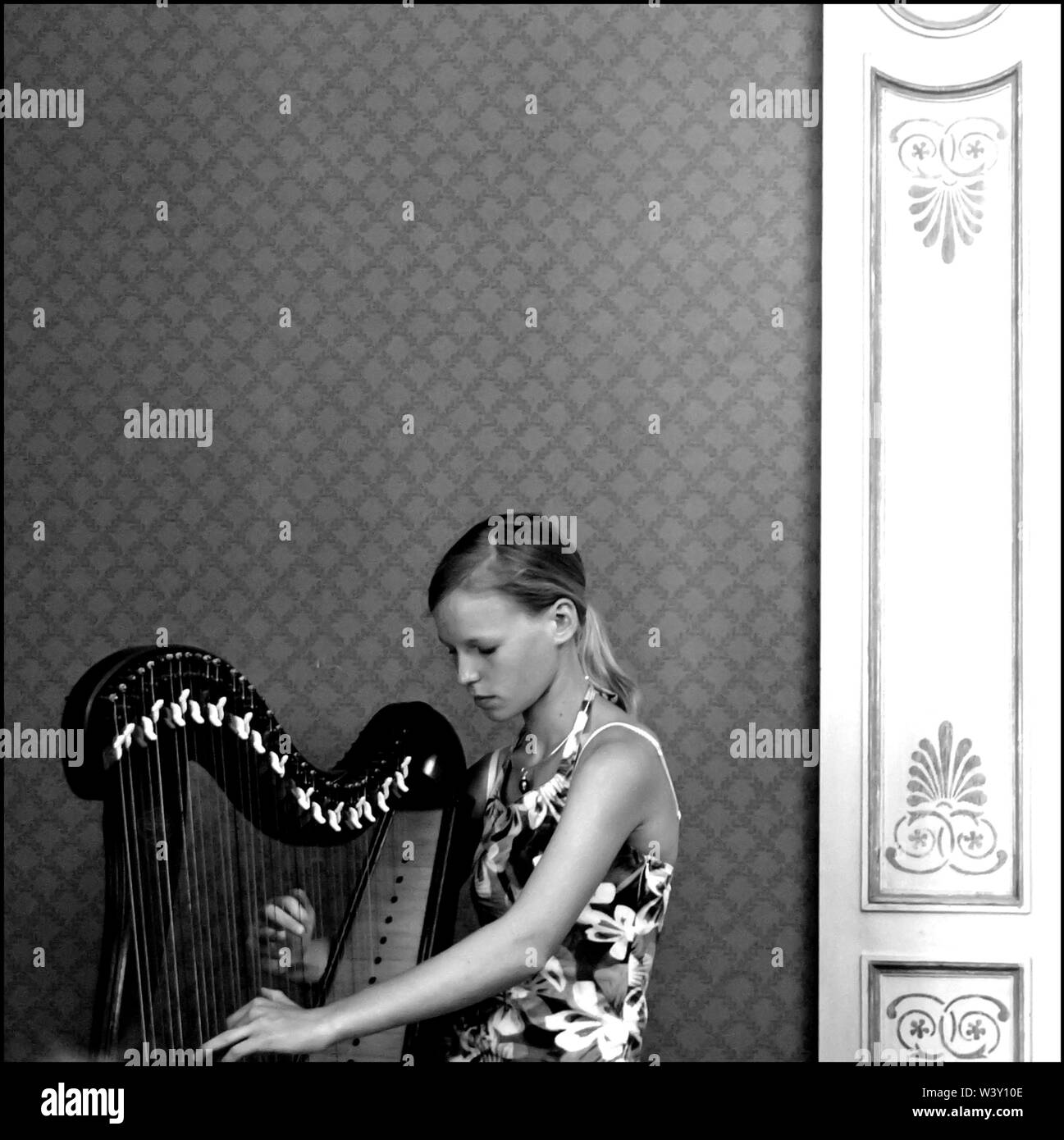 Girl playing harp hi-res stock photography and images - Alamy