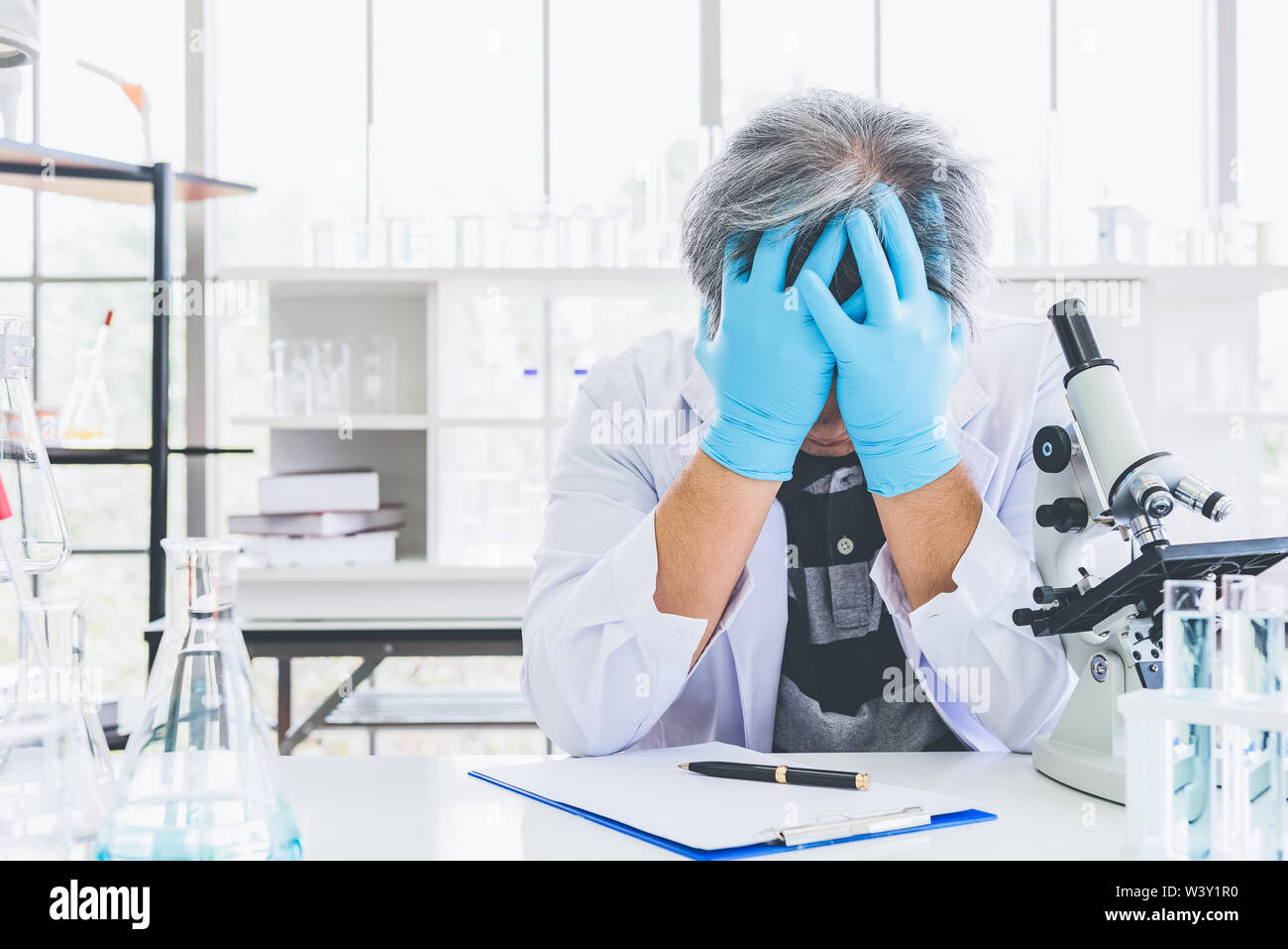 Exhausted scientist sleeping in laboratory. People lifestyles and ...