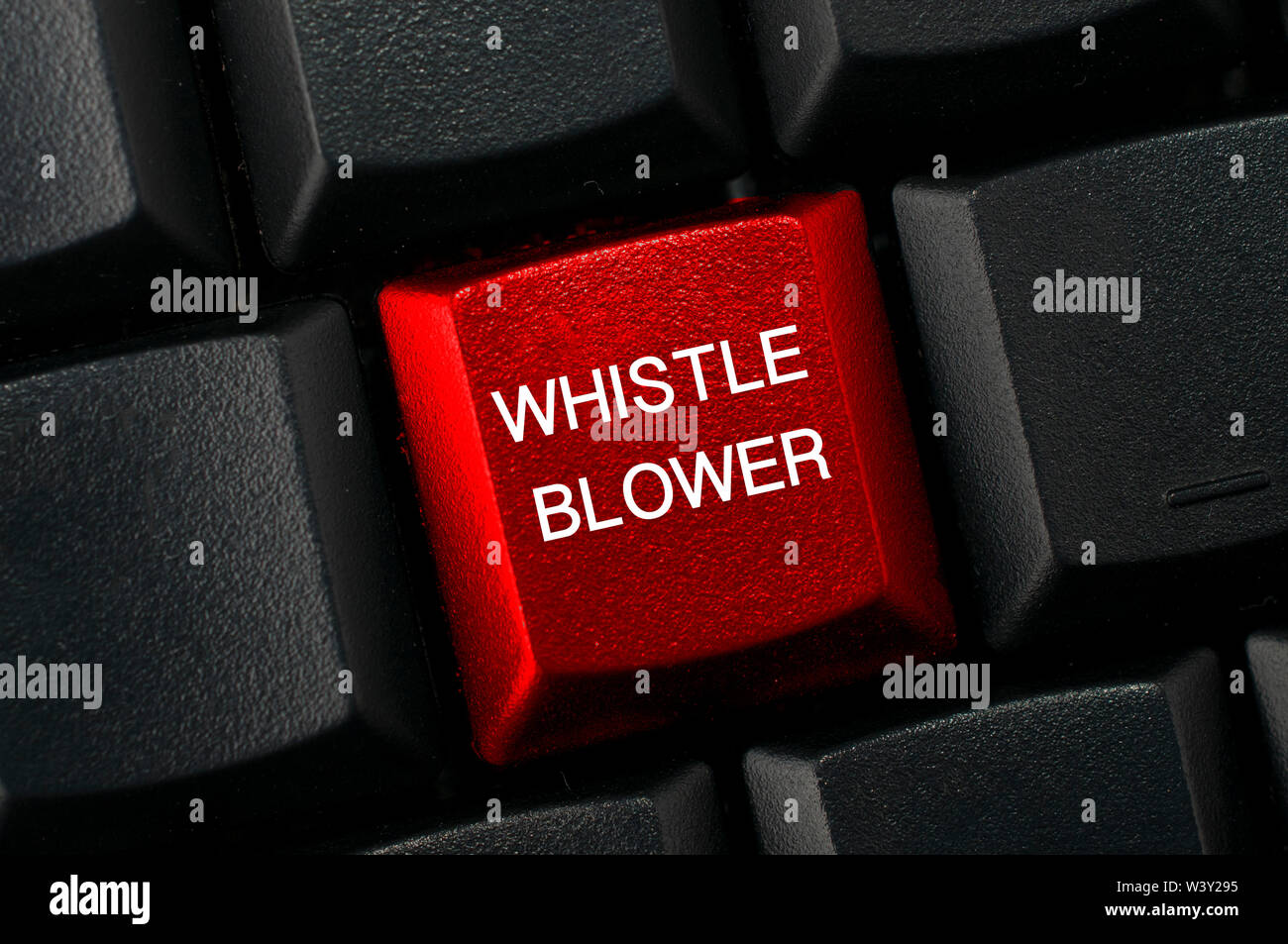 Whistleblowing concept: Black keyboard with a red key and the ...