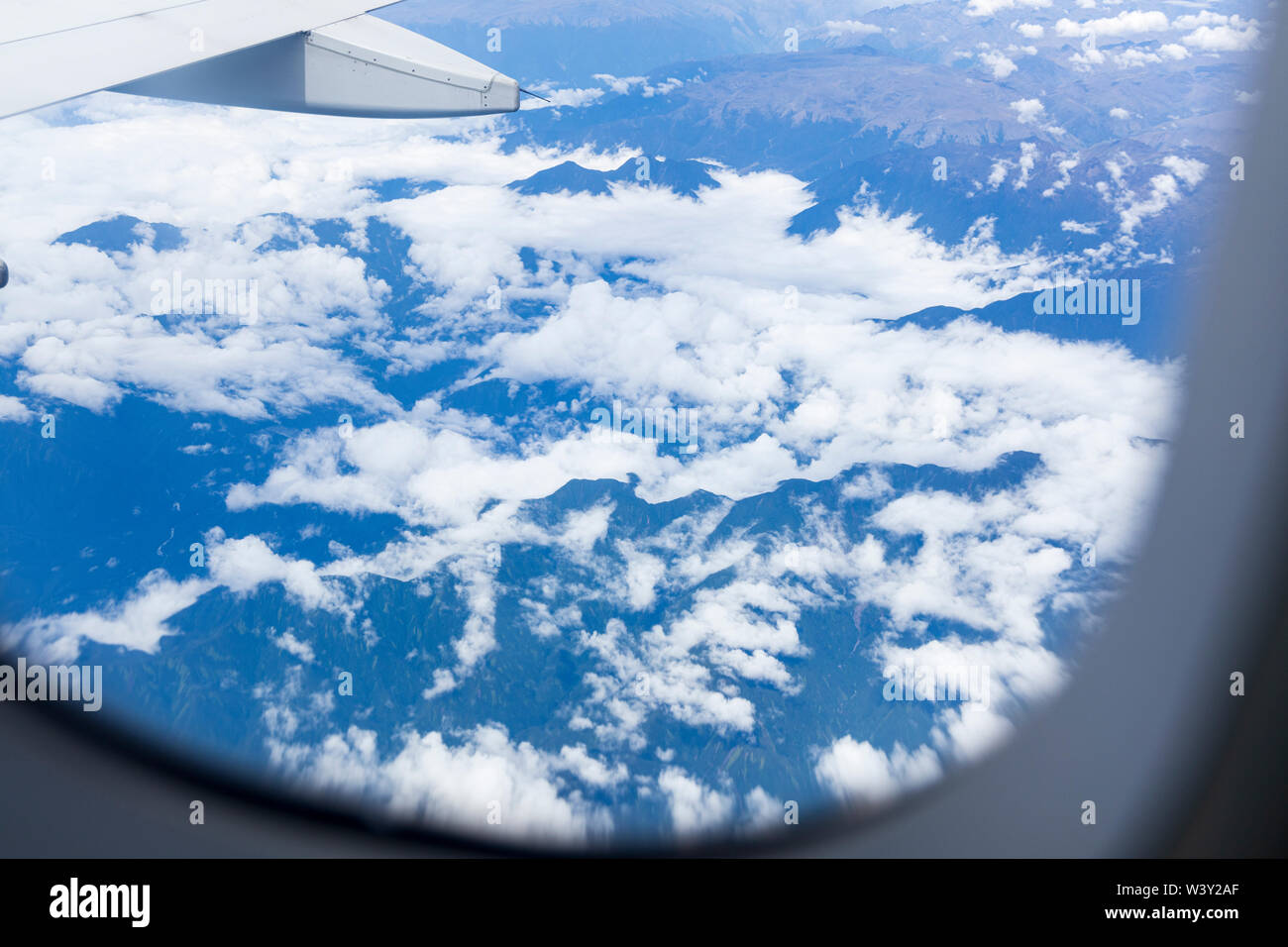 Aerial view over the Andes mountain range from inside a passenger plane ...