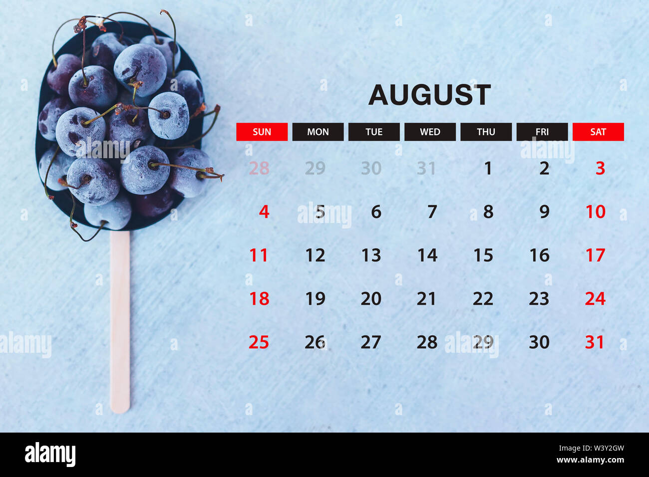 August calendar. Stack of frozen sweet cherries with August month ...