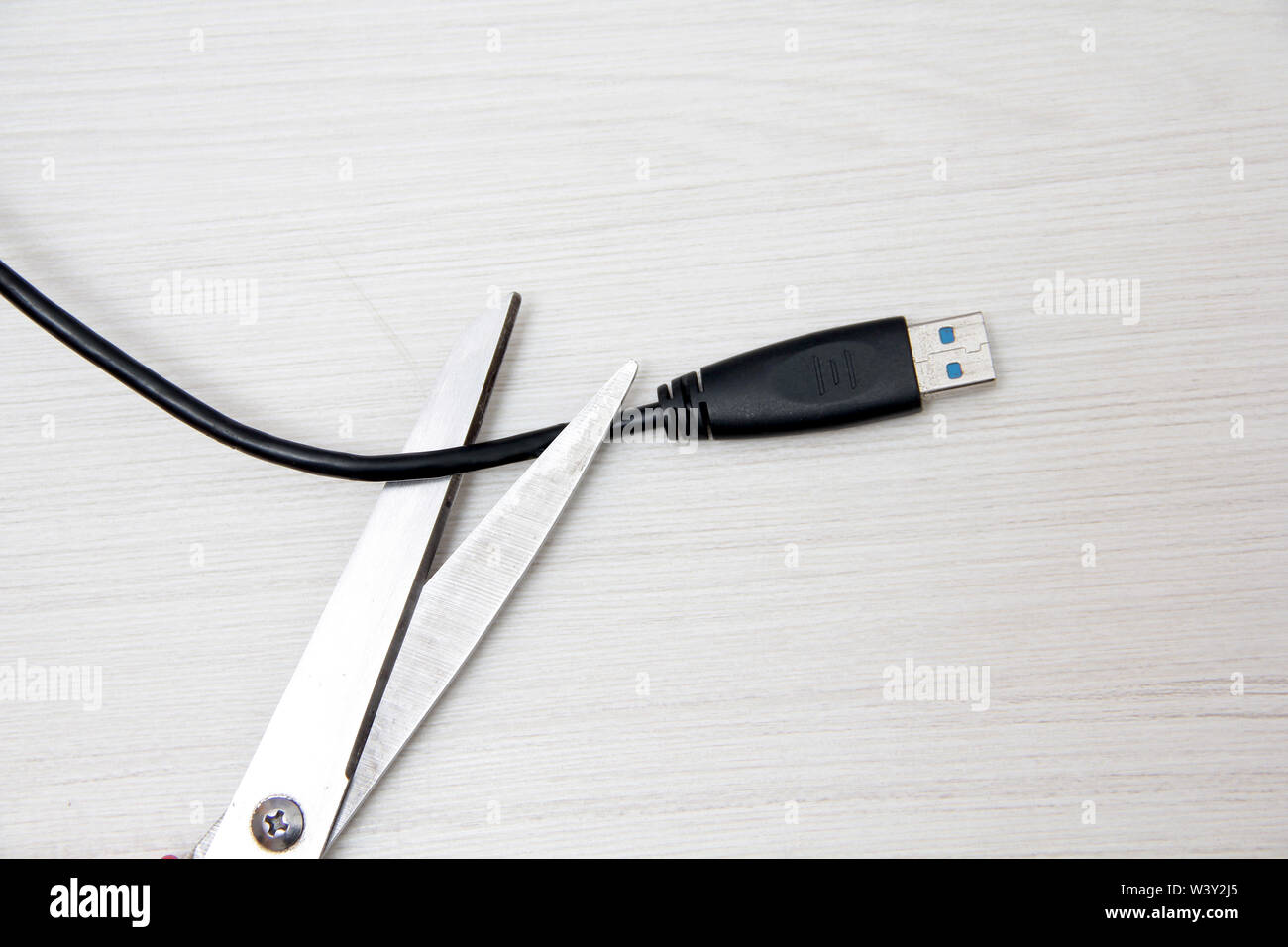 tesura cutting usb cable on white background Stock Photo - Alamy