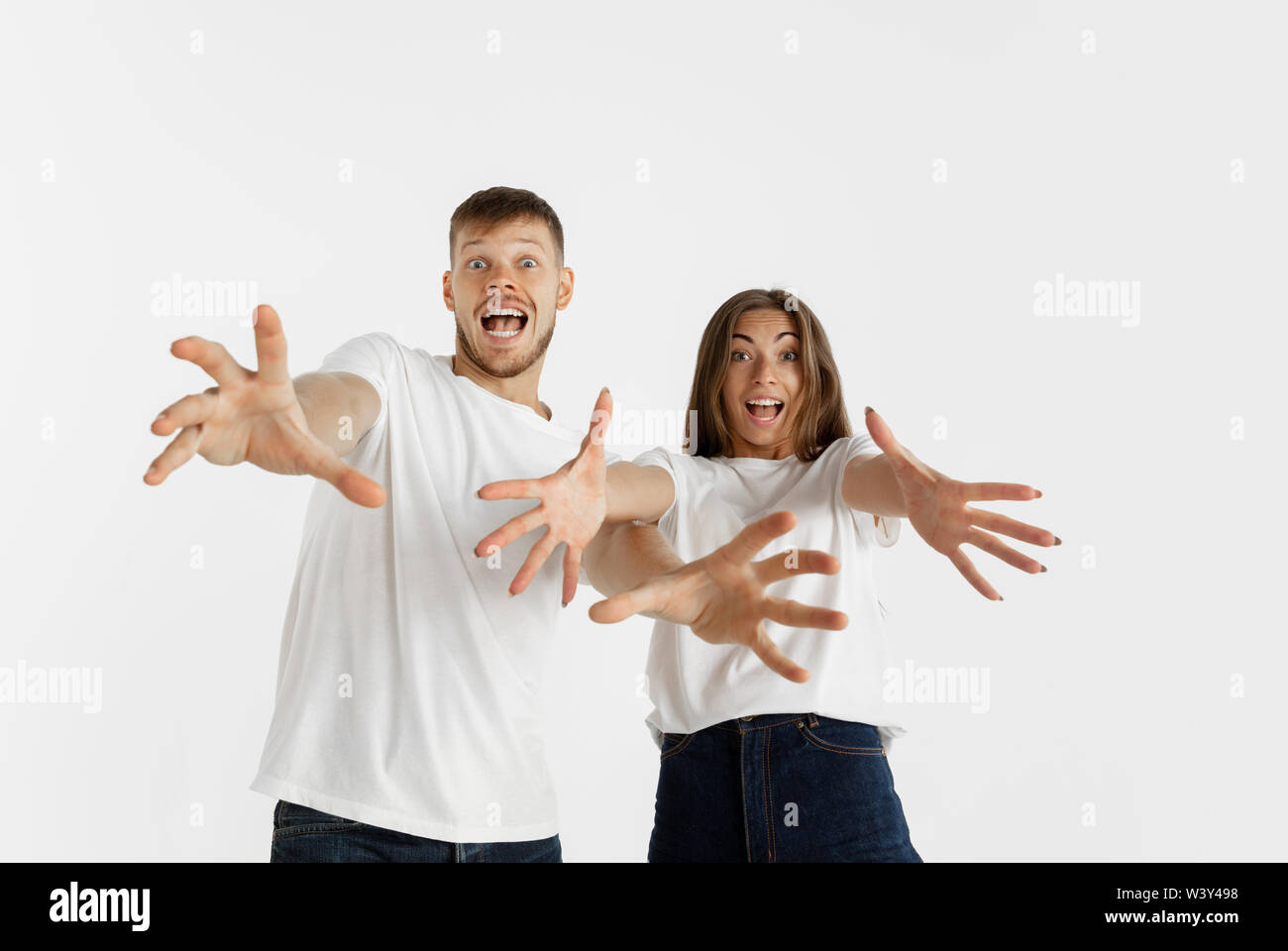 Beautiful young couple's portrait isolated on white studio background ...