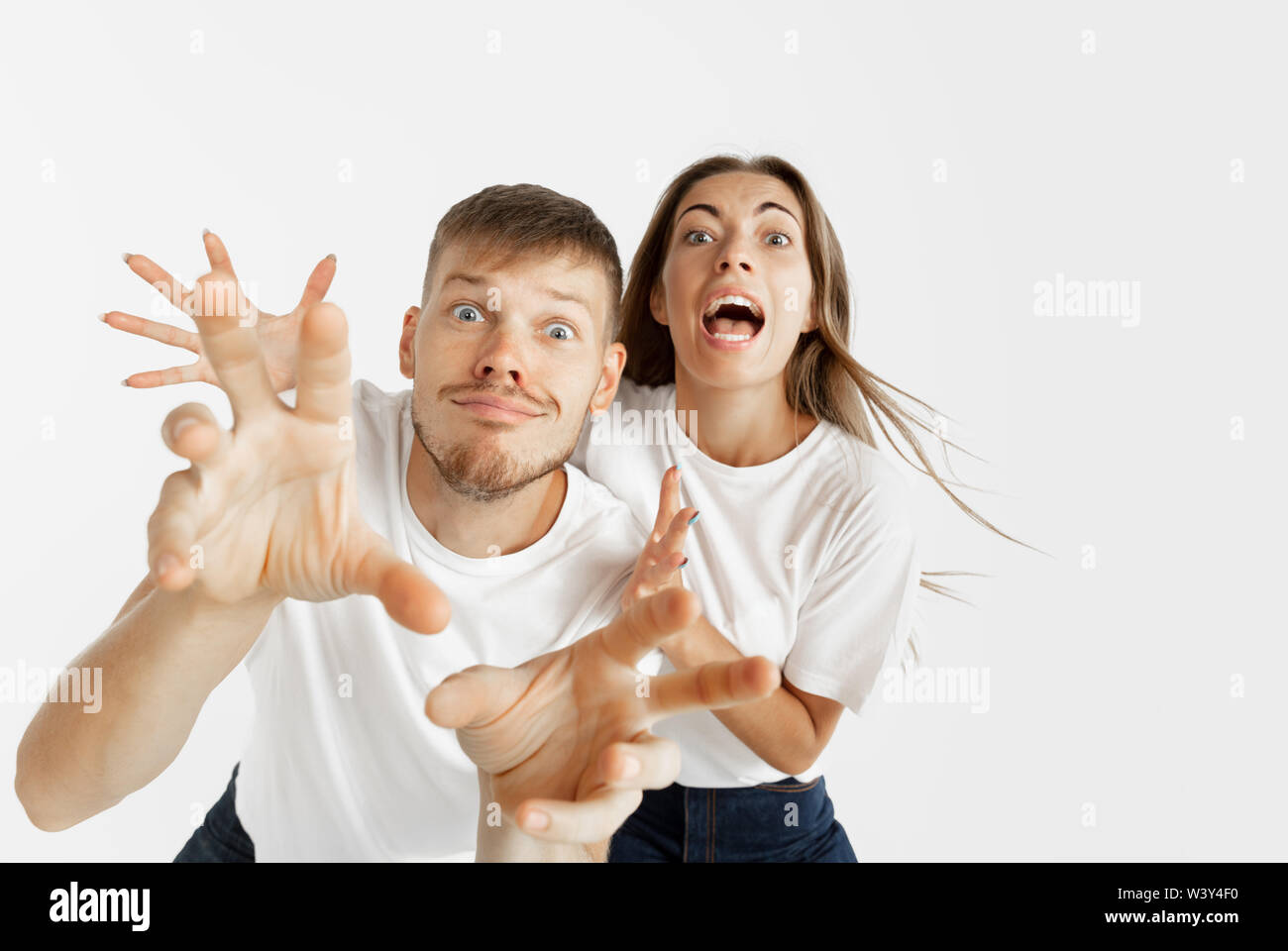 Beautiful young couple's portrait isolated on white studio background ...