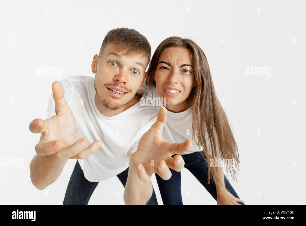 Beautiful young couple's portrait isolated on white studio background ...
