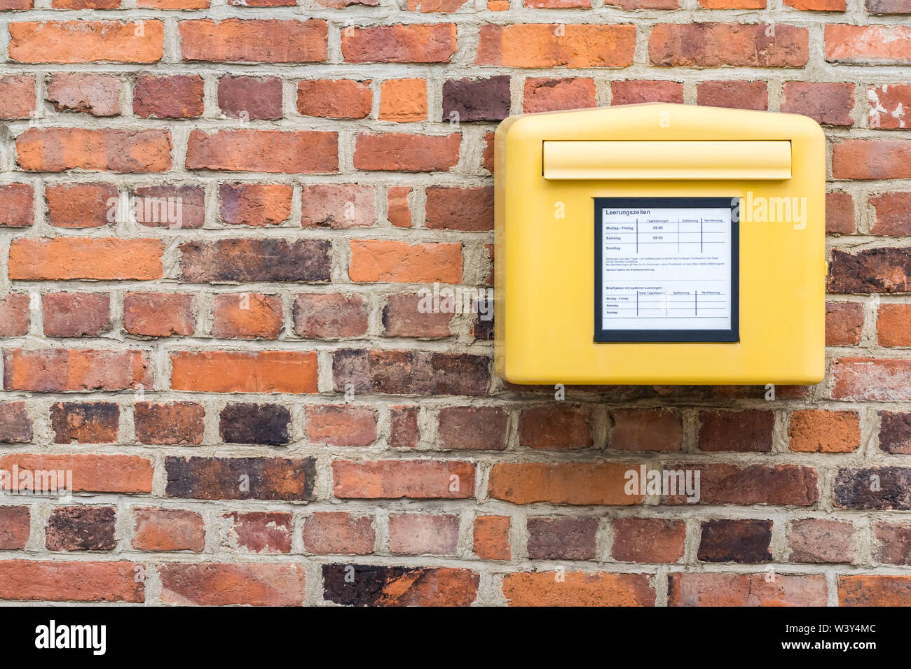german letterbox deutsche post on brick wall Stock Photo - Alamy