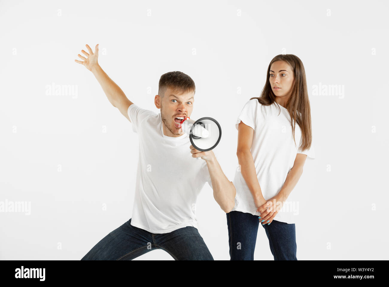Beautiful young couple's portrait isolated on white studio background ...