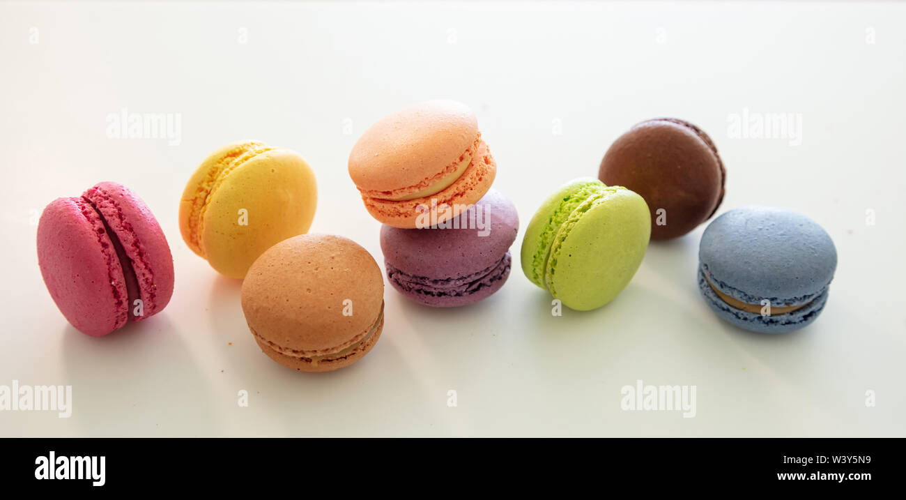Macarons pastel colors with chocolate cream on white background, close ...