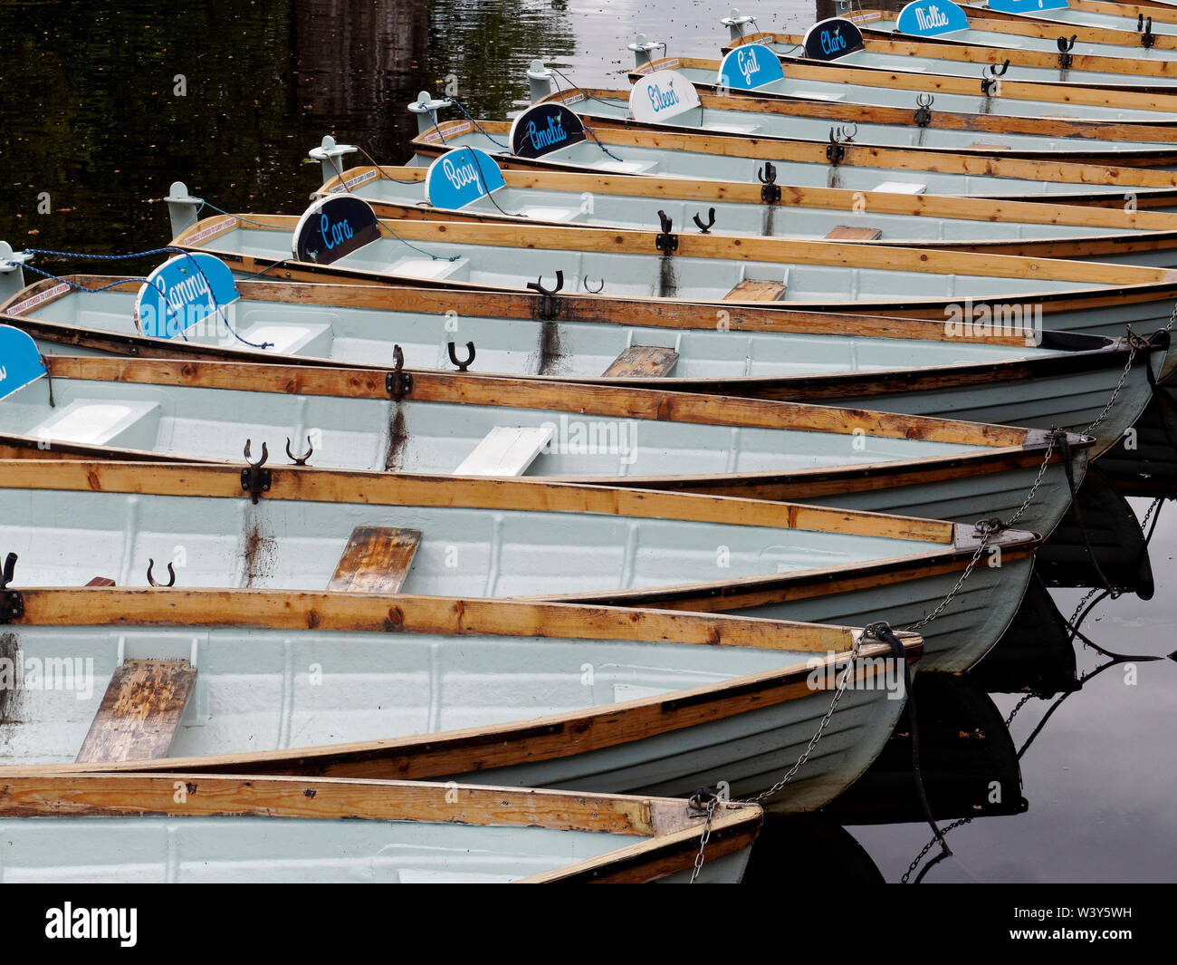 Rowing boats for hire tied up alongside a quay on the River Nidd in ...