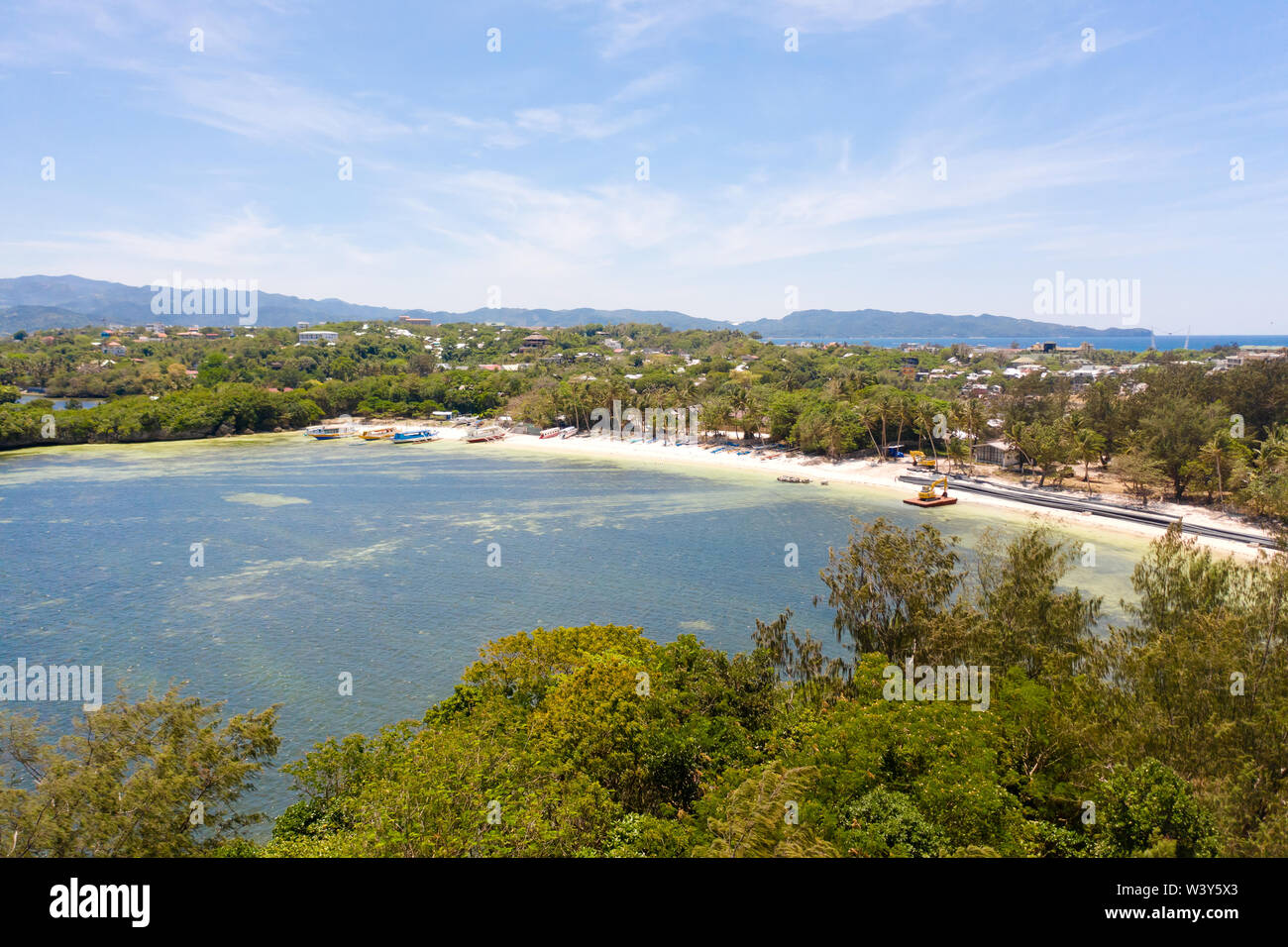Beautiful lagoon with boats and tourist beach. White beach on the ...