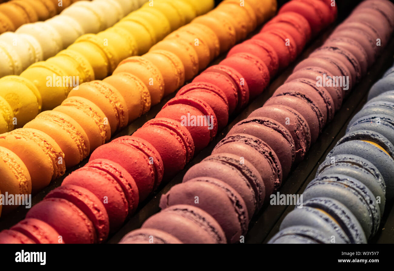 Macarons assortment background texture. French store display, close up ...
