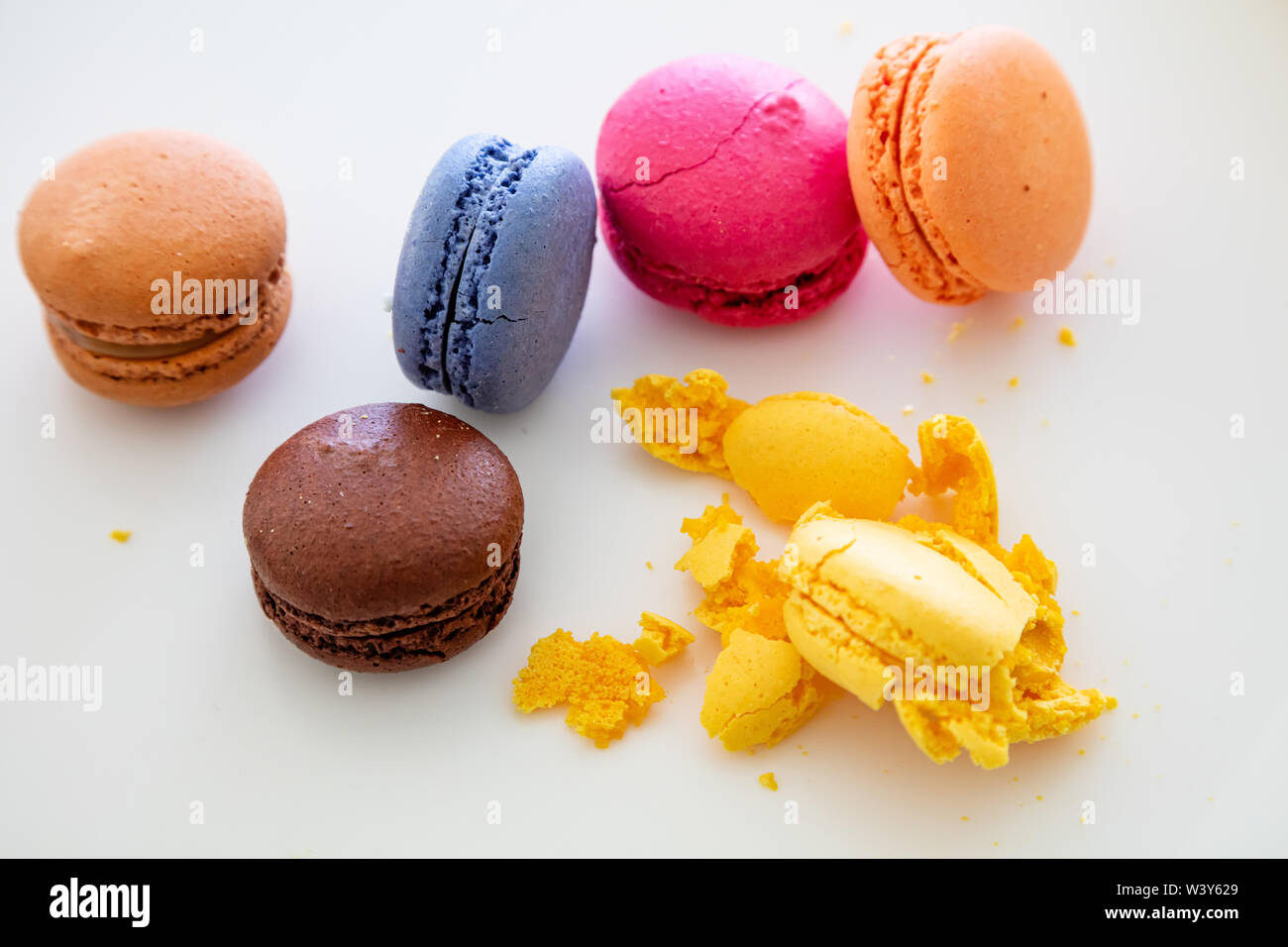 Macarons pastel colors with chocolate cream on white background, close ...