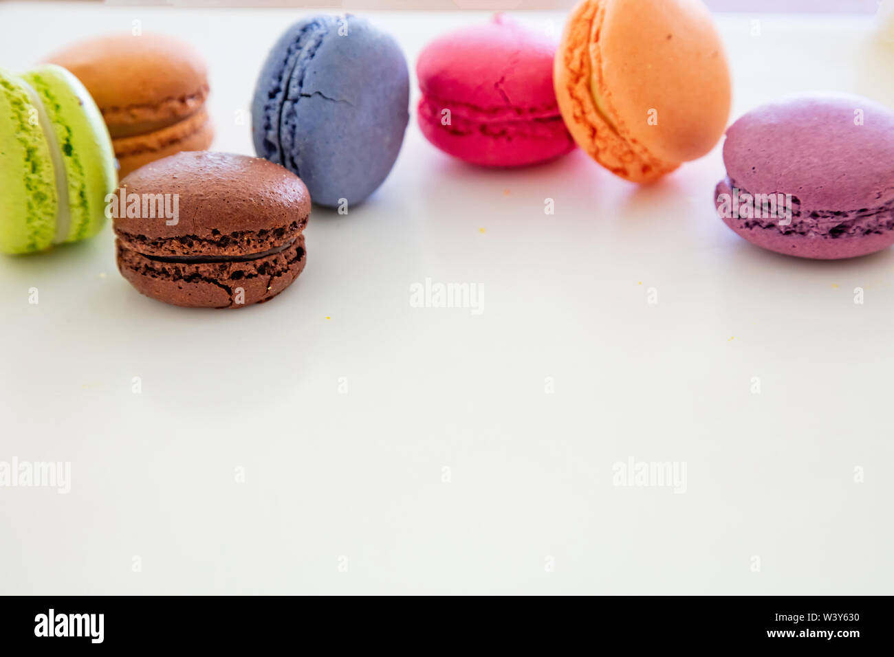 Macarons pastel colors with chocolate cream on white background, close ...