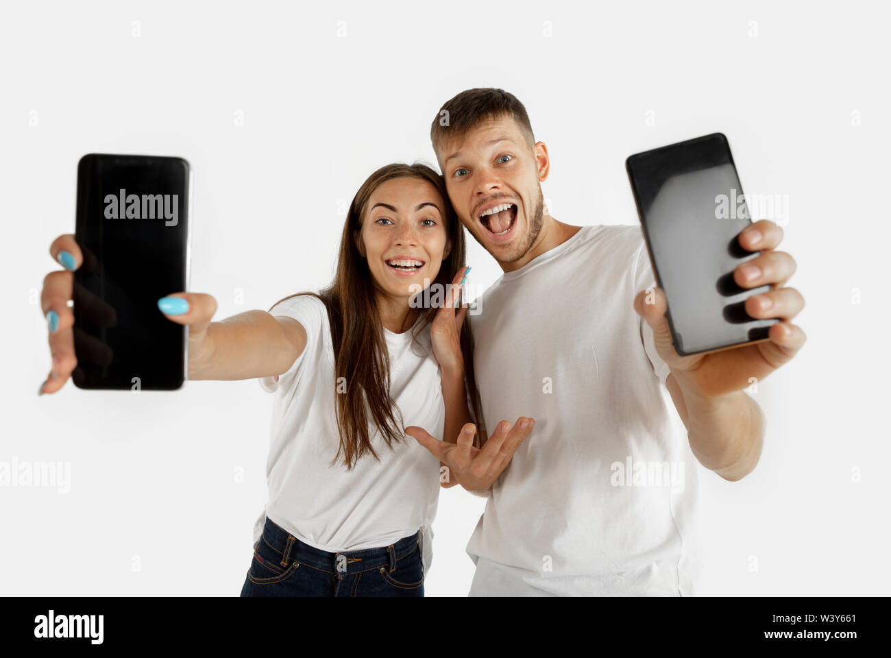 Beautiful young couple's portrait isolated on white studio background ...