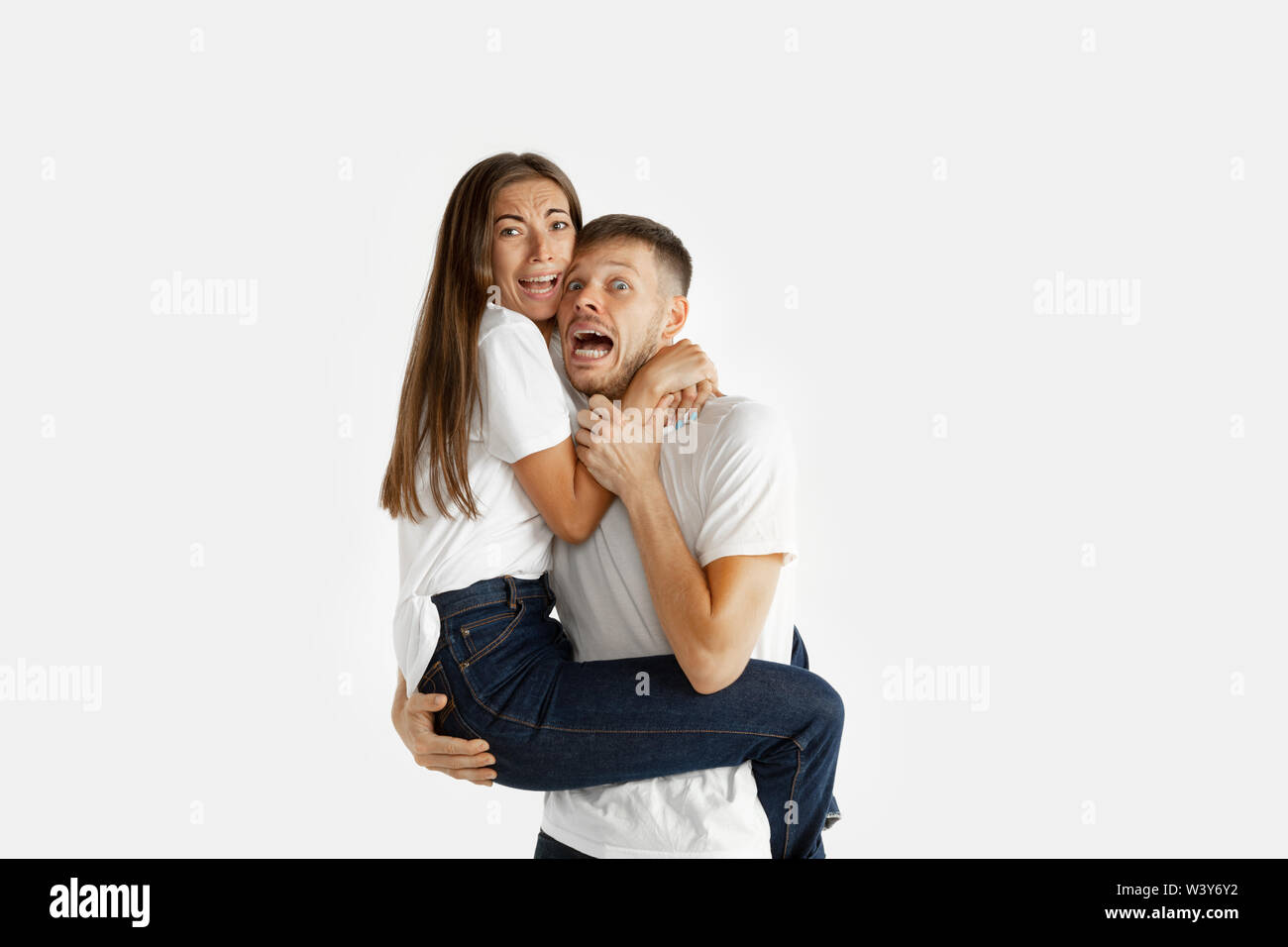 Beautiful young couple's portrait isolated on white studio background ...