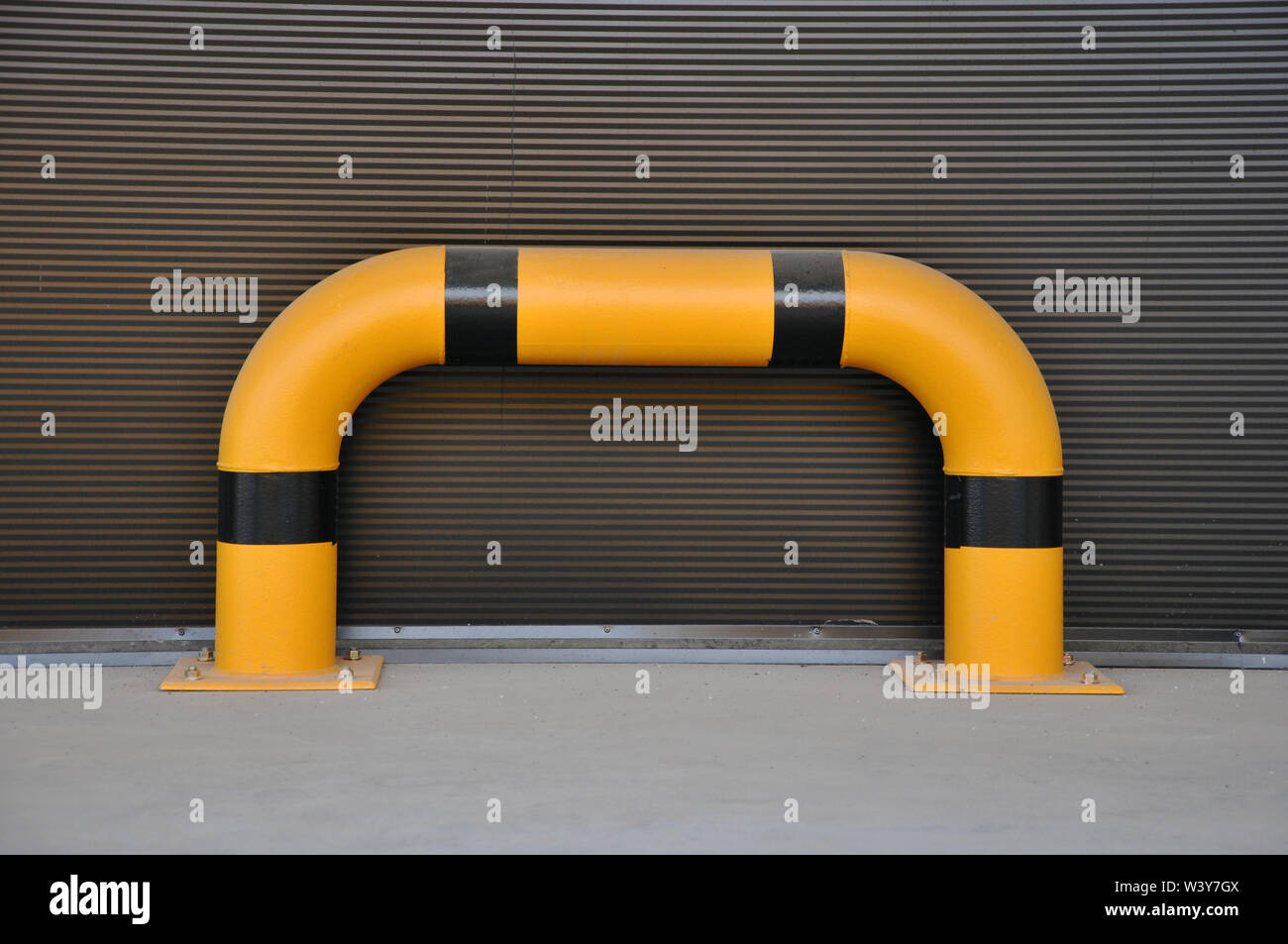 Protection of wheels at the entrance to the warehouse Stock Photo - Alamy