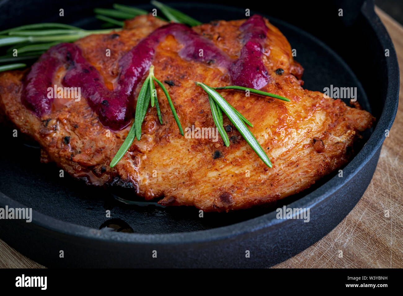 Fried chicken fillet in a paprika marinade with wild berry sauce and a ...