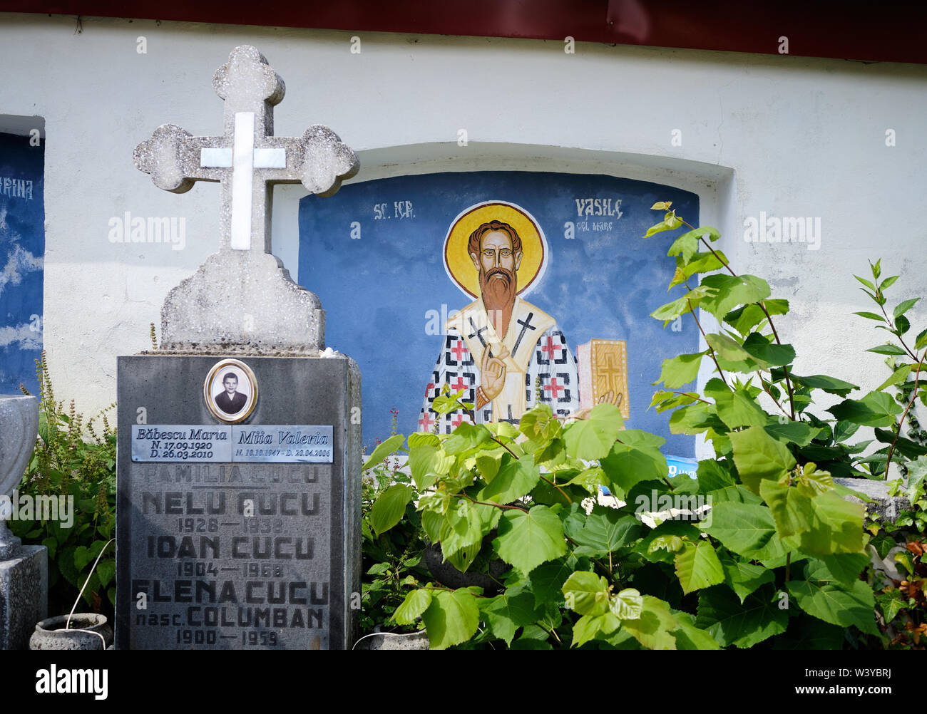 Painted wall facade with image of a saint in an Romanian Orthodox ...