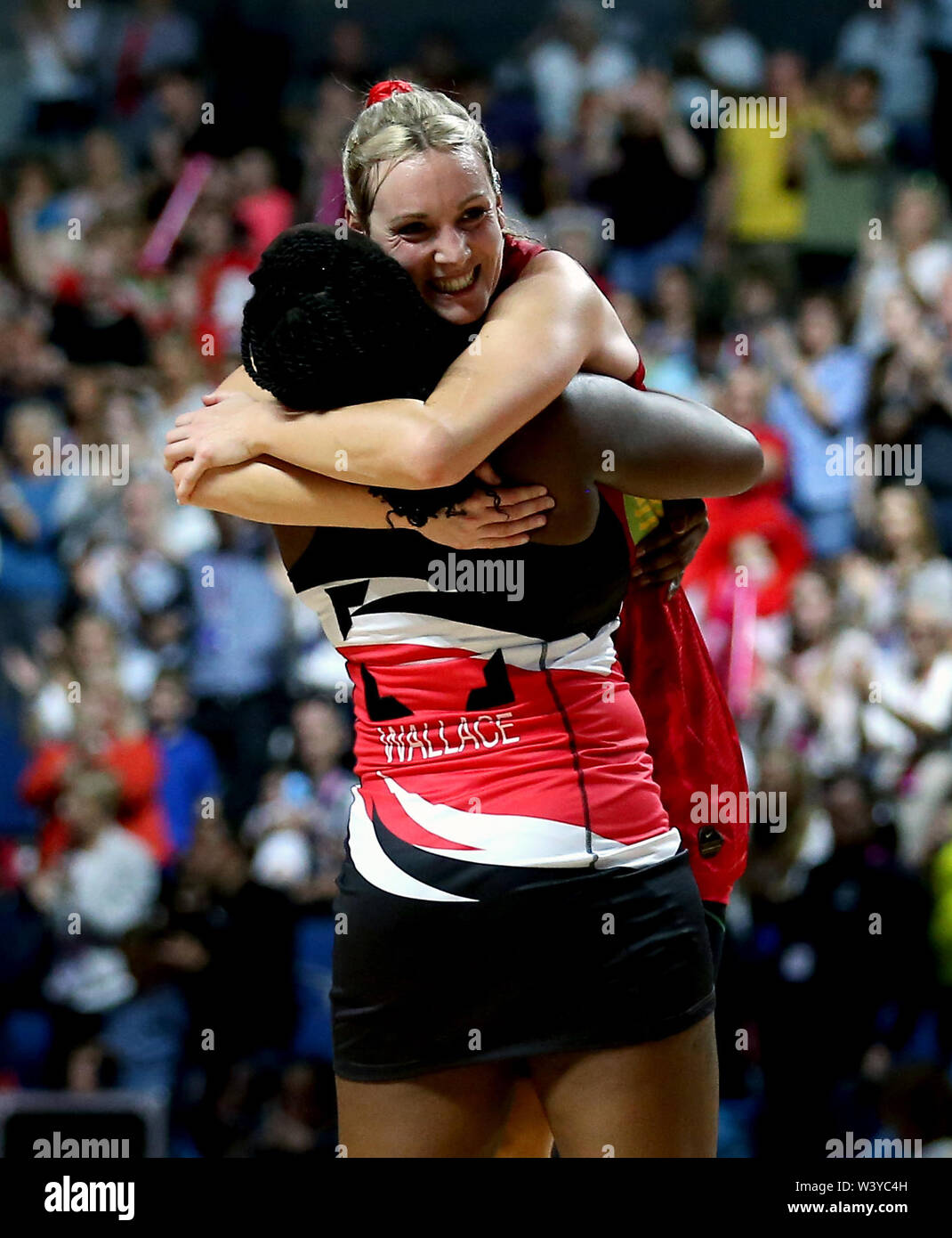 Trinidad and Tobago's Samantha Wallace hugs England's Natalie Panagarry ...