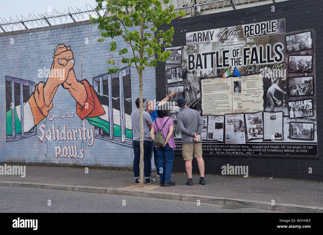 Visitors on a tour of the Republican murals in the Falls Road area of ...