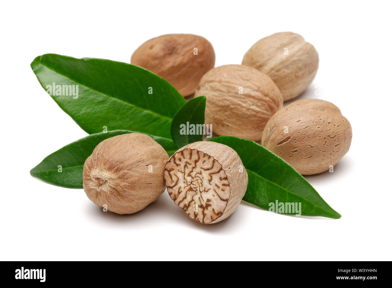 Whole and half nutmeg with leaves isolated on white background Stock ...
