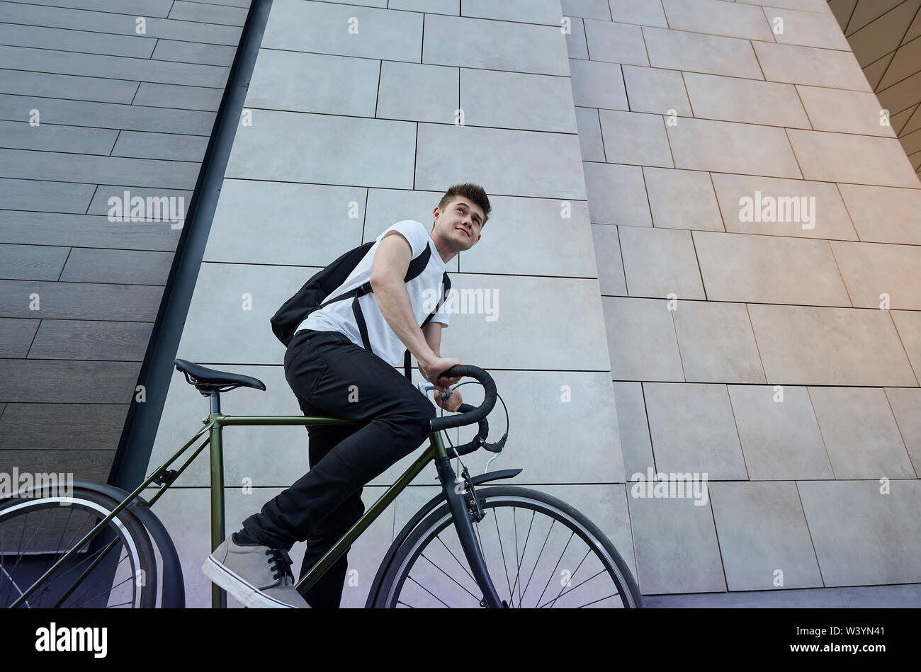Handsome hipster man posing with bicycle in the city Stock Photo - Alamy