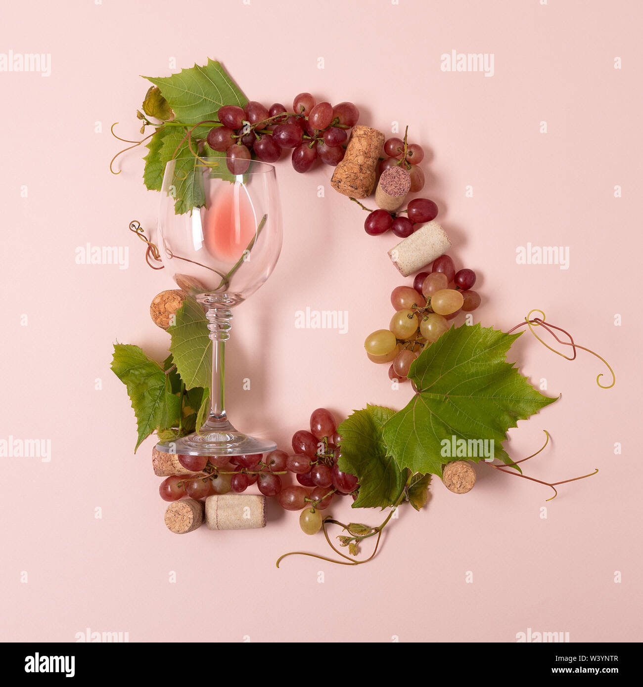 Alphabet. Letter D made of wineglasses with rose and white wine, grapes ...