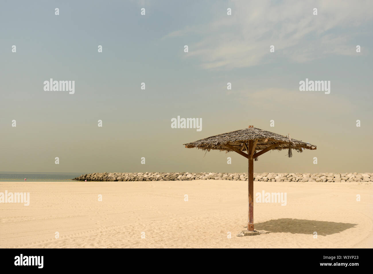 Thatched Parasol on an empty Gold Beach. Vintage. Al Mamzar, Dubai ...