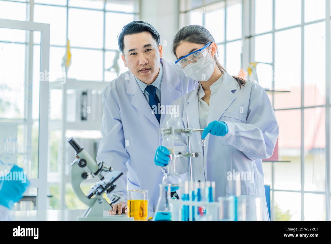 A handsome asian professor proud to teaching biology and chemist for ...