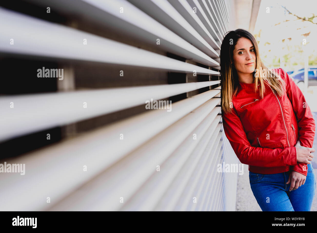 Portrait of young girl in red and blue clothes with proud attitude of ...