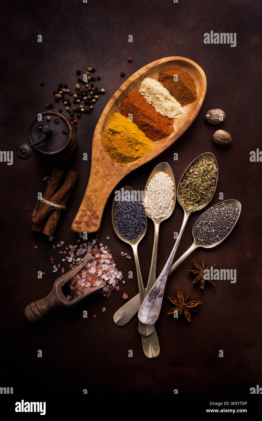 still life with colorful spices and seeds in wooden bowl Stock Photo ...