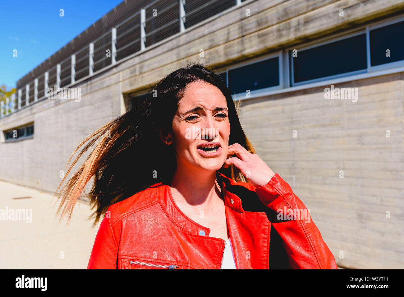 Scared woman is scared and makes a panic face while screaming for help ...