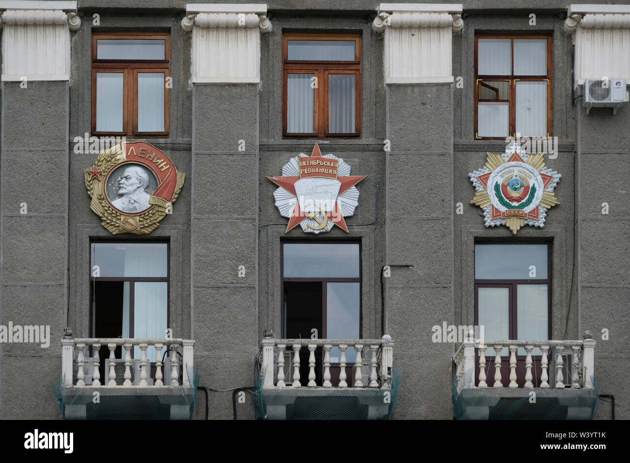 Soviet emblems placed at the facade of the government courthouse in ...